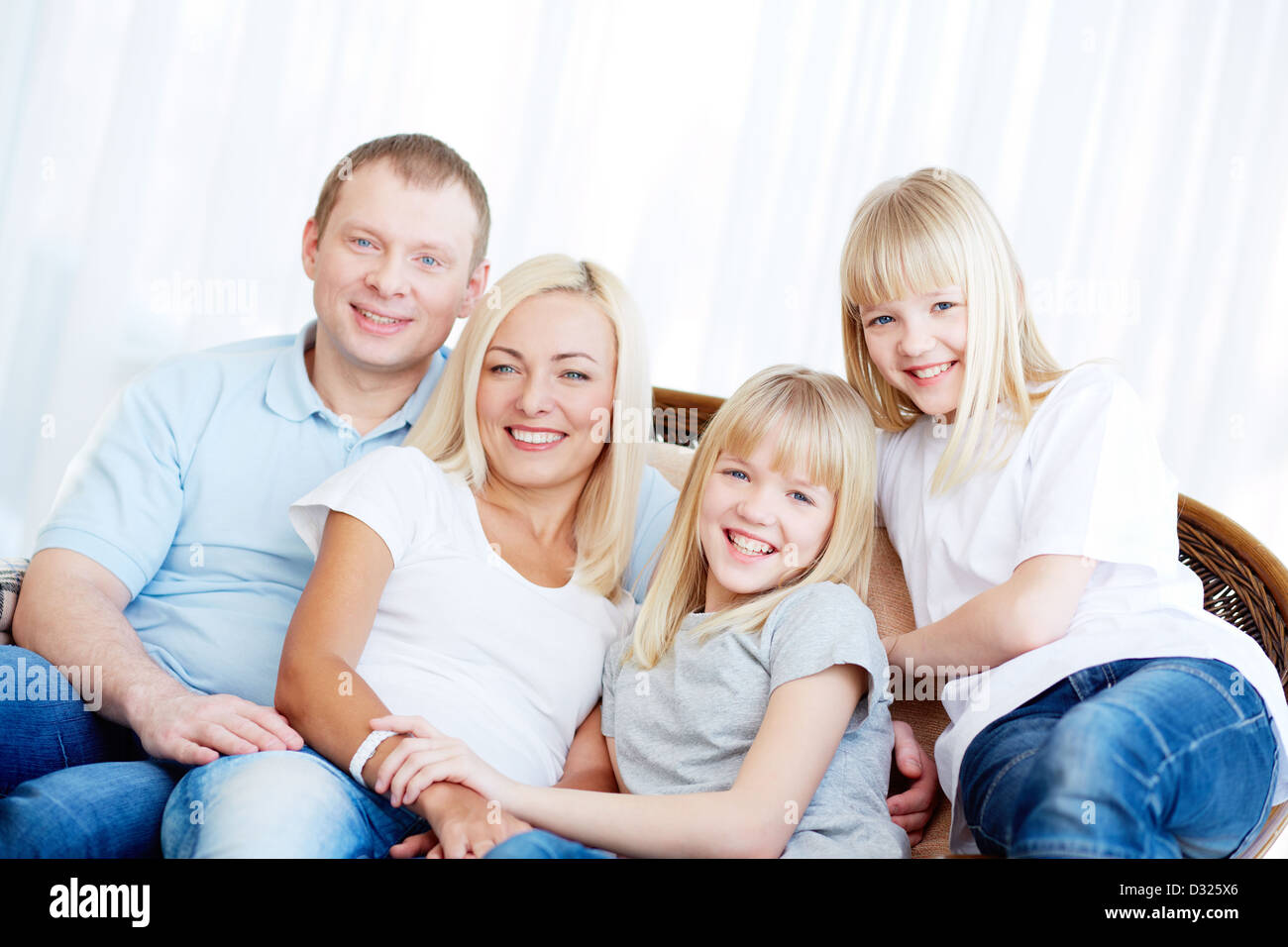 Portrait of happy family with two children smiling at camera Stock ...