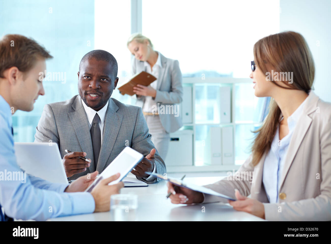 Portrait of confident boss looking at employee during interaction at ...