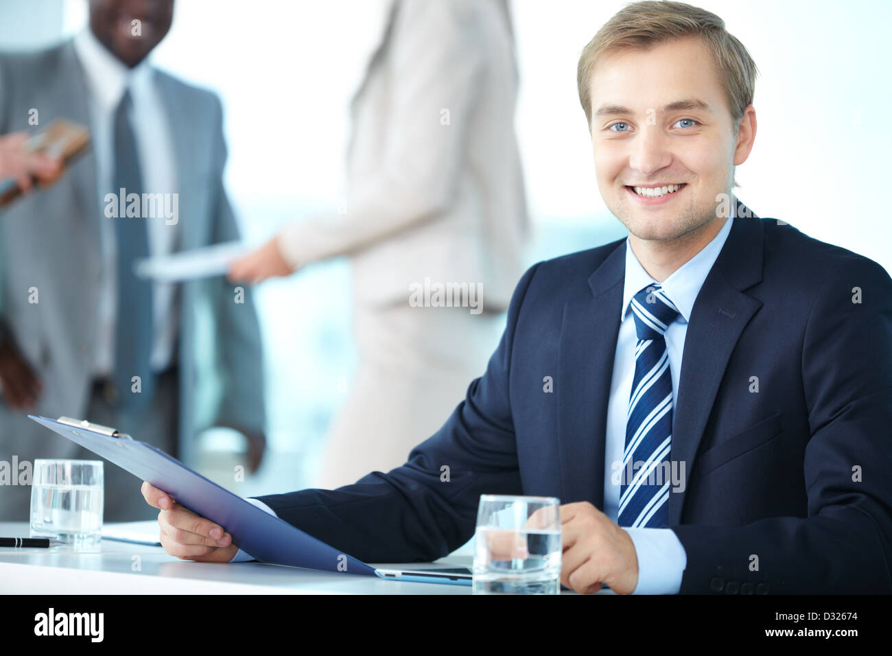 Portrait of elegant boss with clipboard looking at camera Stock Photo ...