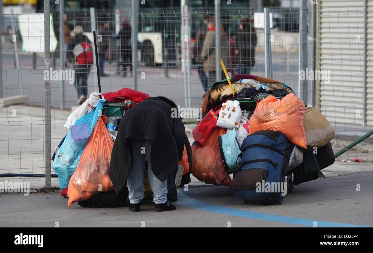 A homeless woman packs her belongings together at the central station ...