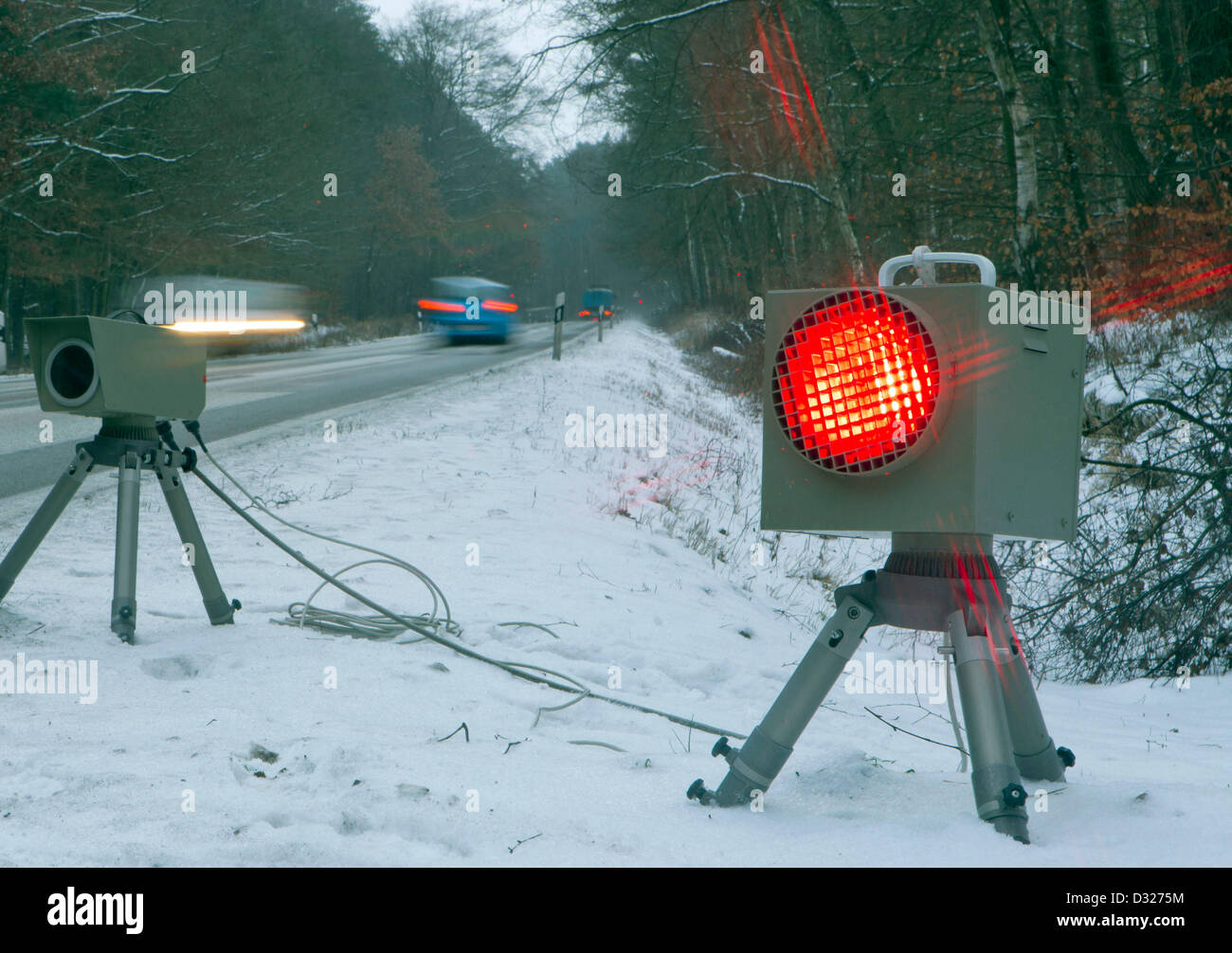 The illustration shows a speed control camera in operation along a ...