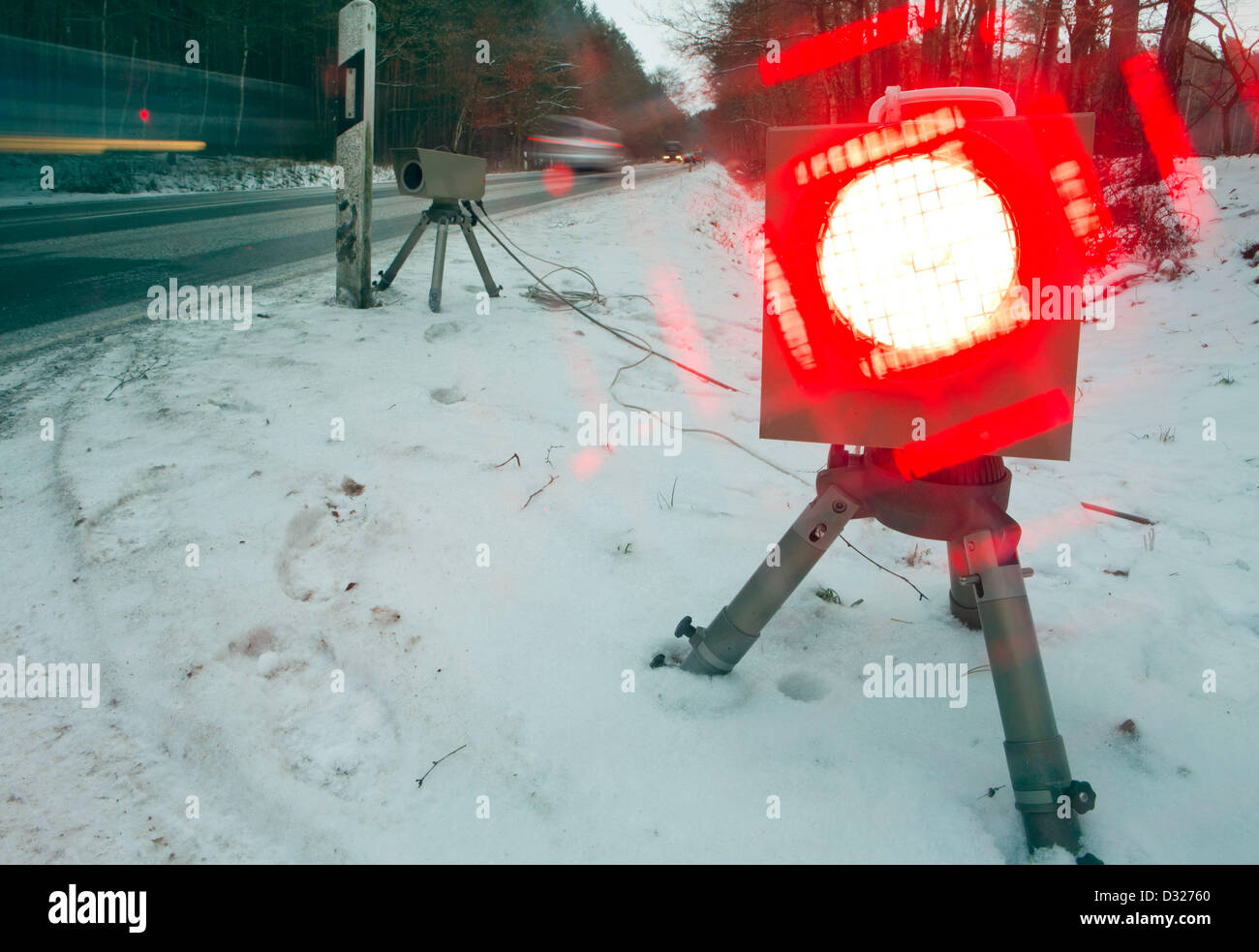The illustration shows a speed control camera in operation along a ...