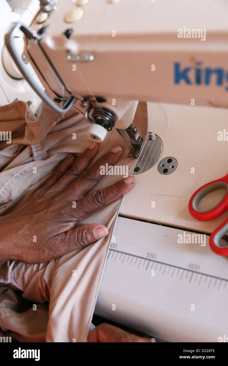 African hands sewing on a machine Stock Photo - Alamy
