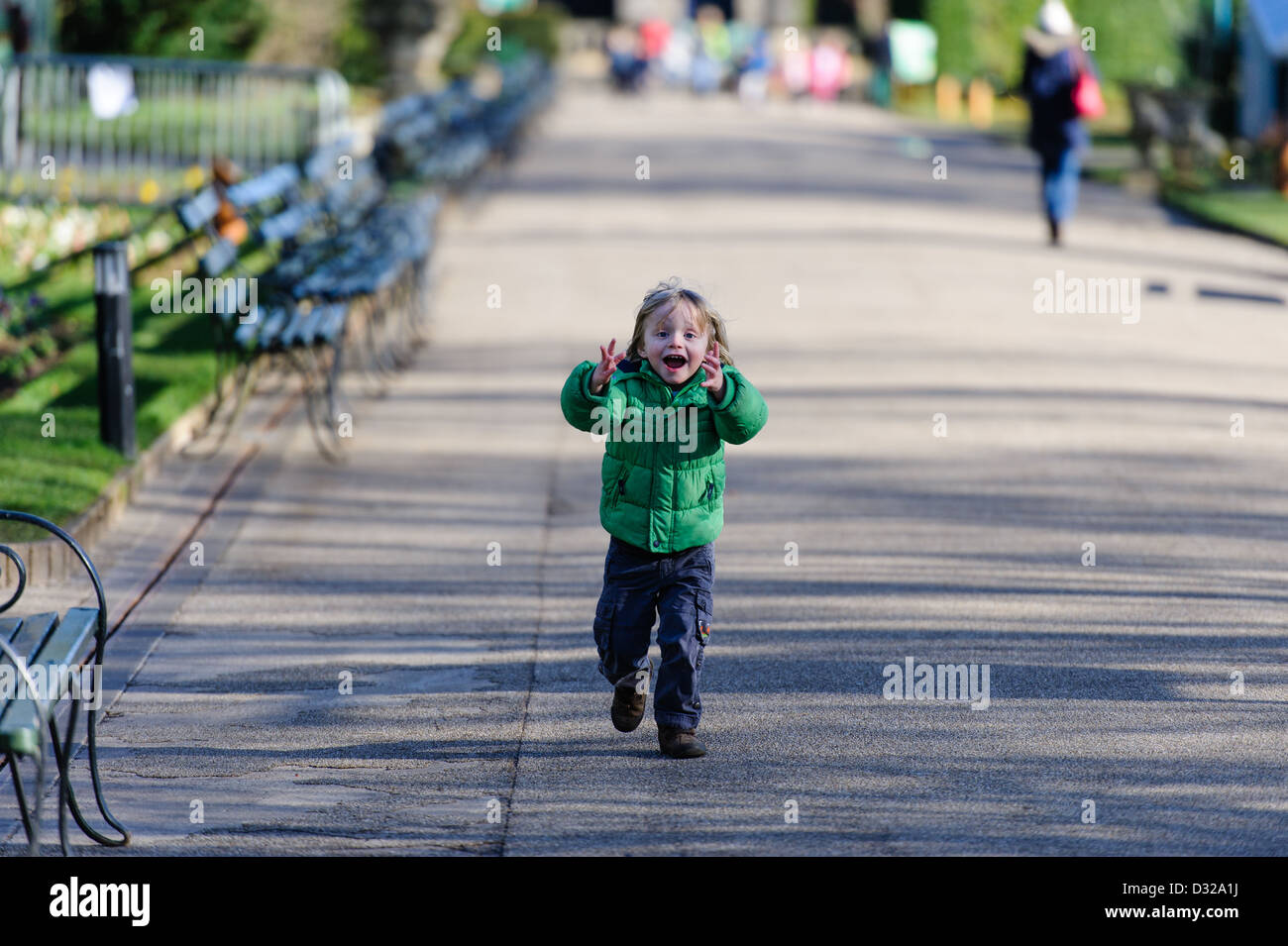 happy little boy running down a path towards camera Stock Photo - Alamy