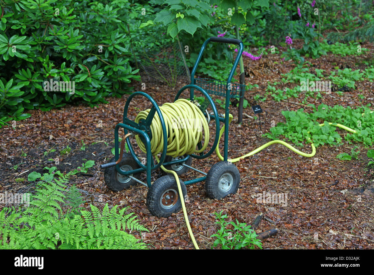 An industrial sized portable wheeled garden hose on its own trolley ...