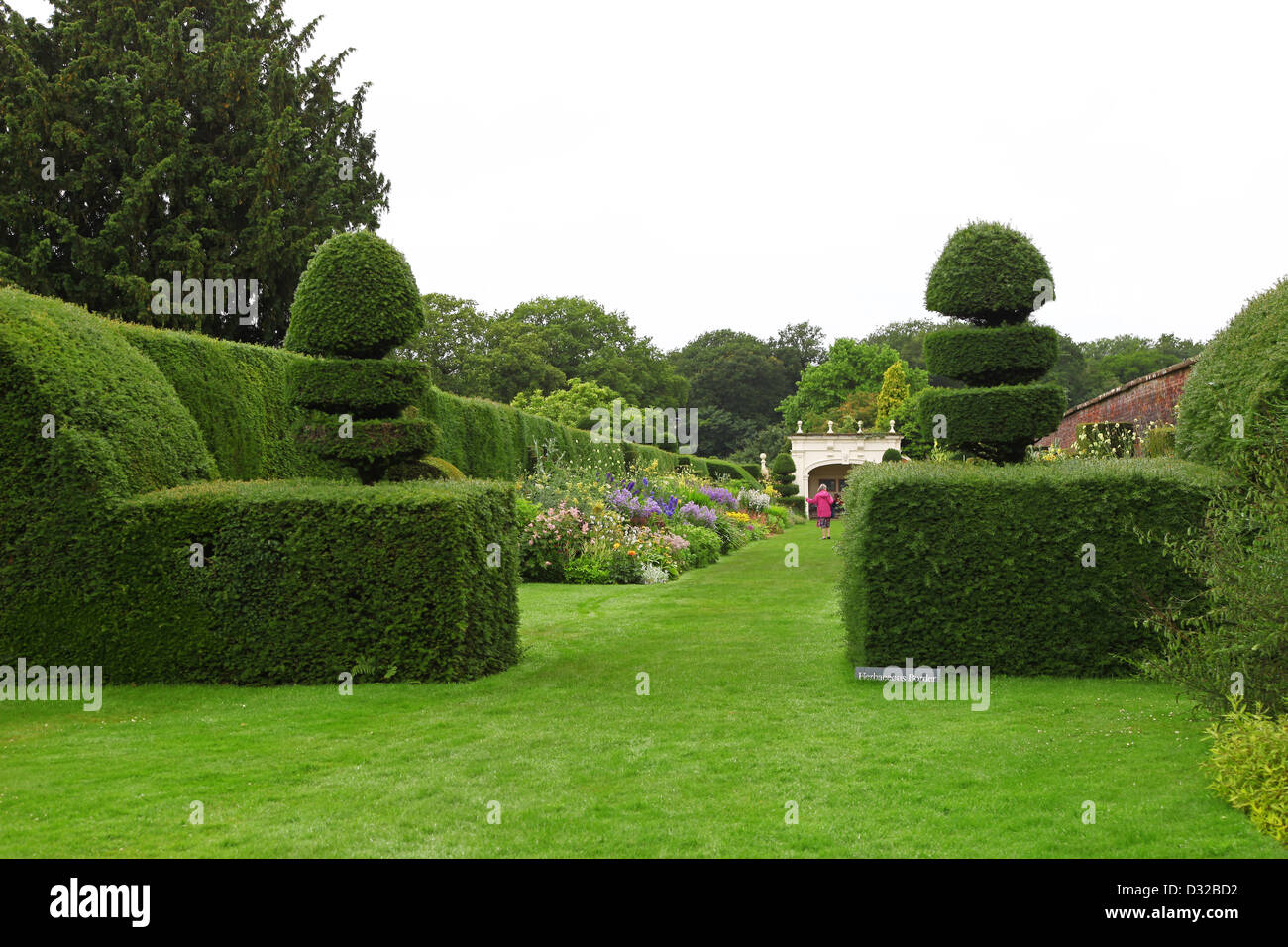 The formal planting and topiary in the herbaceous border looking toward ...