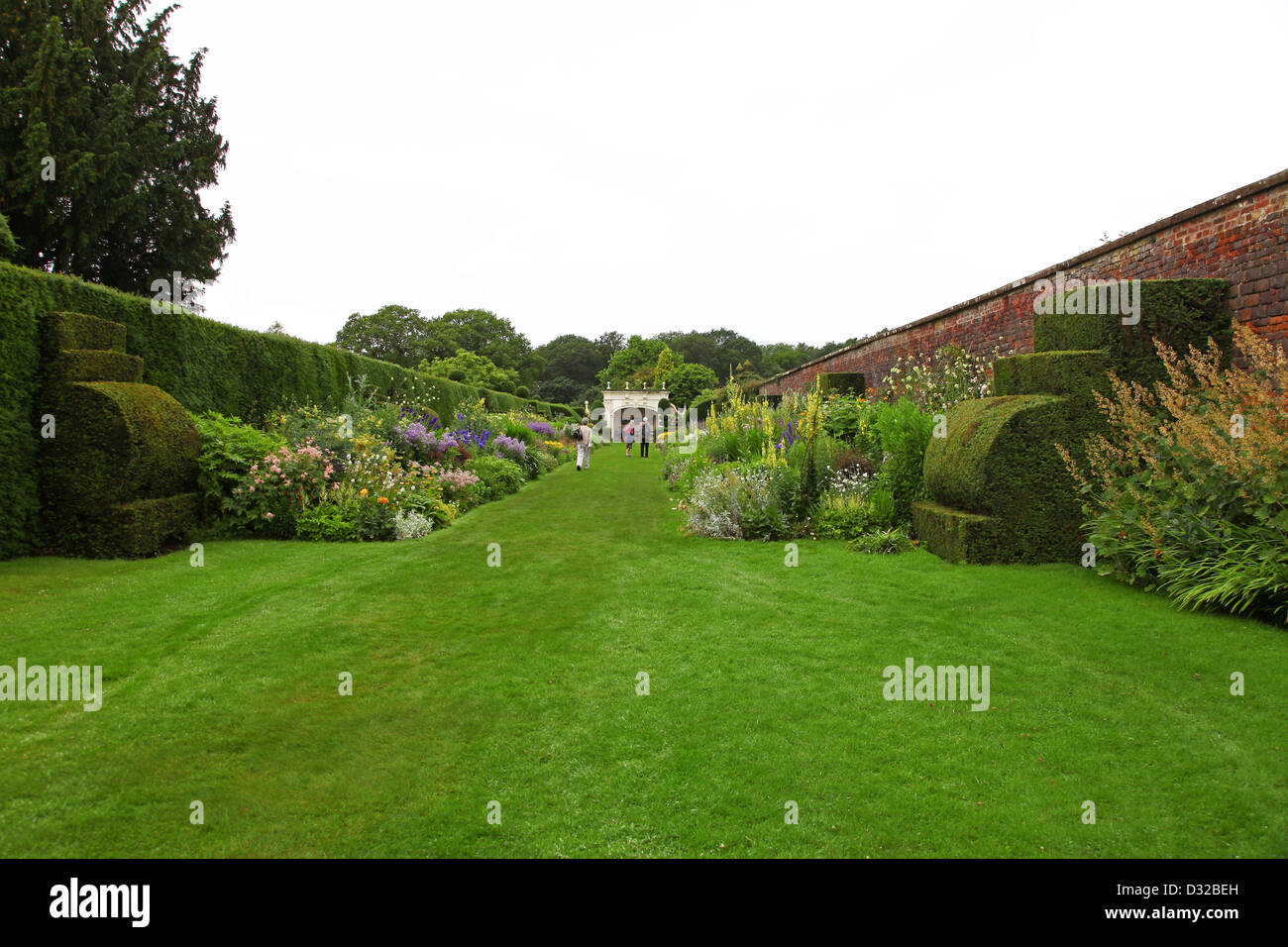 The formal planting and topiary in the herbaceous border looking toward ...