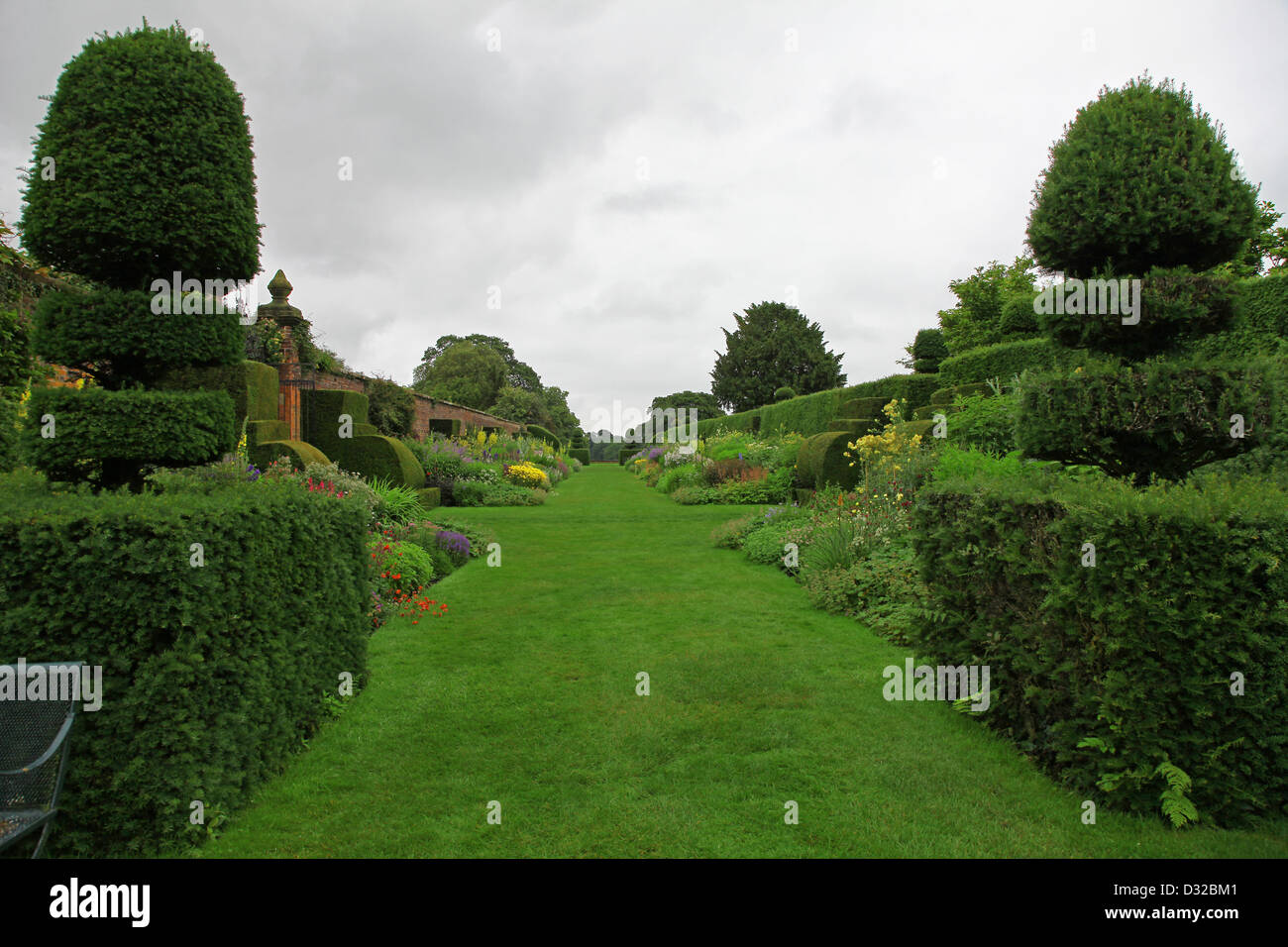 The formal planting and topiary in the herbaceous border looking toward ...