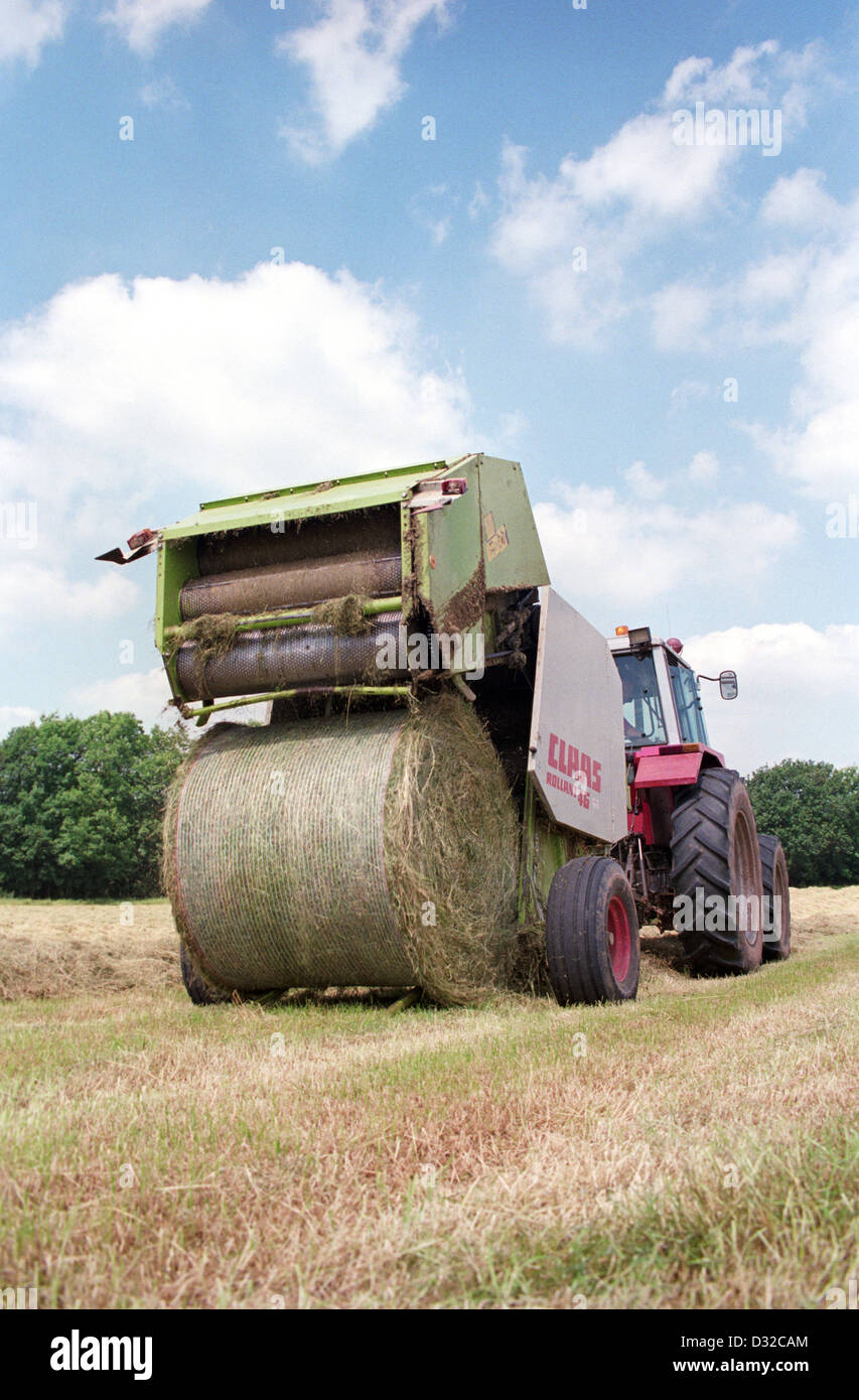 Farm machinery baling and wrapping silage, Warwickshire, England Stock ...