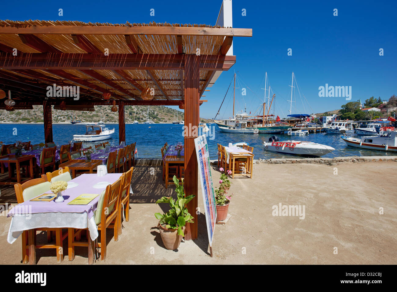 Waterfront seating area of a local restaurant. Gumusluk, Mugla province ...
