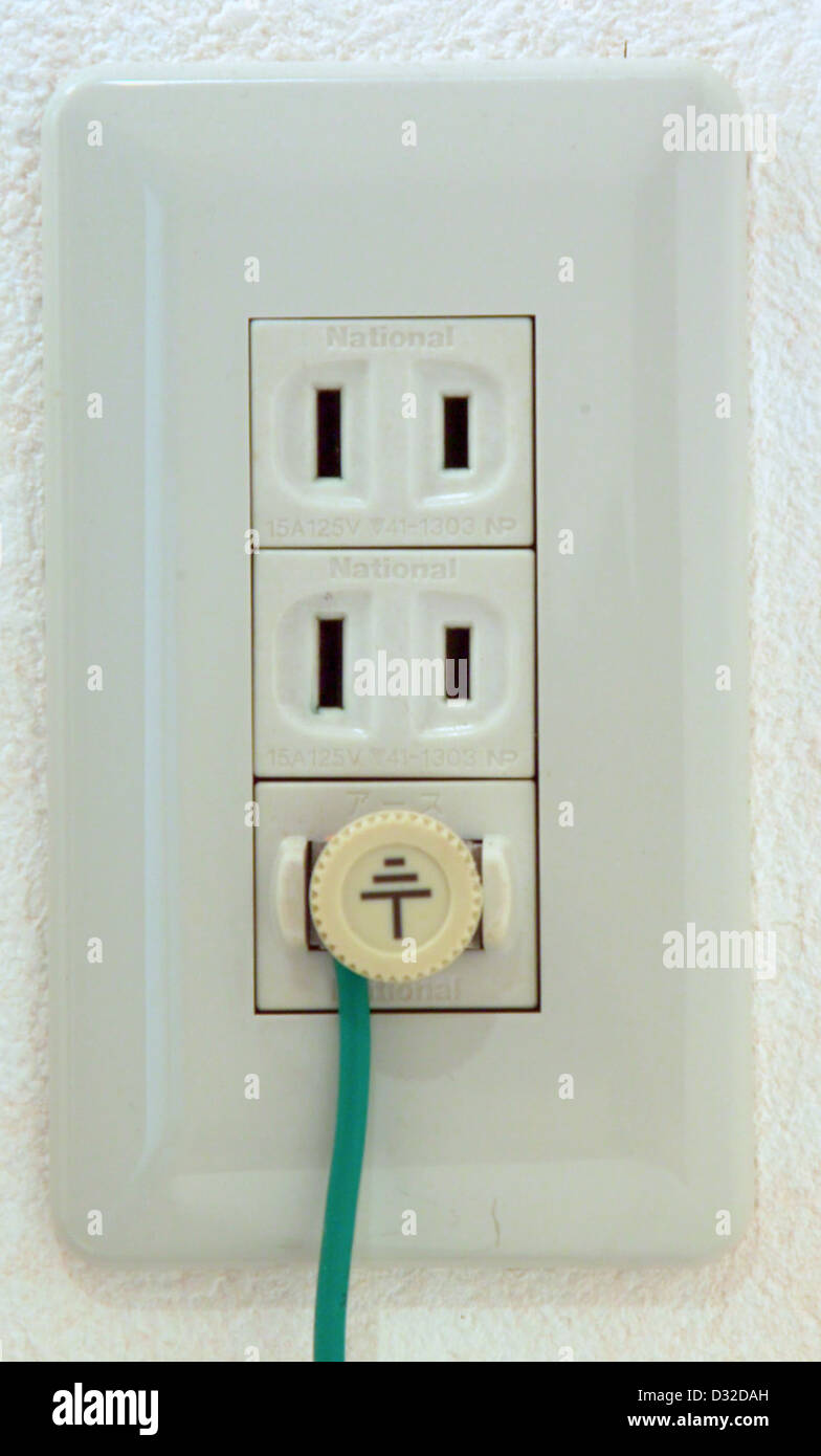 This image shows a standard Japanese household wall outlet with a ...