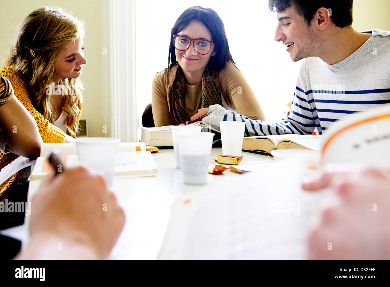 Young adults studying and having discussions and chatting Stock Photo ...