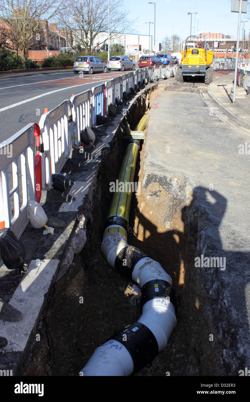 Roadworks,the laying of a new pipeline along a busy mainroad Stock ...