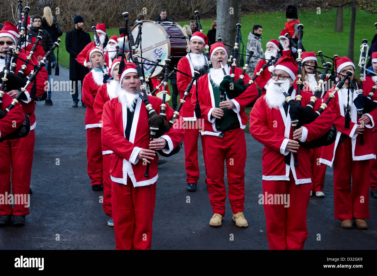 Pipe band in Santa costumes playing at the charity "Santa Run" in ...