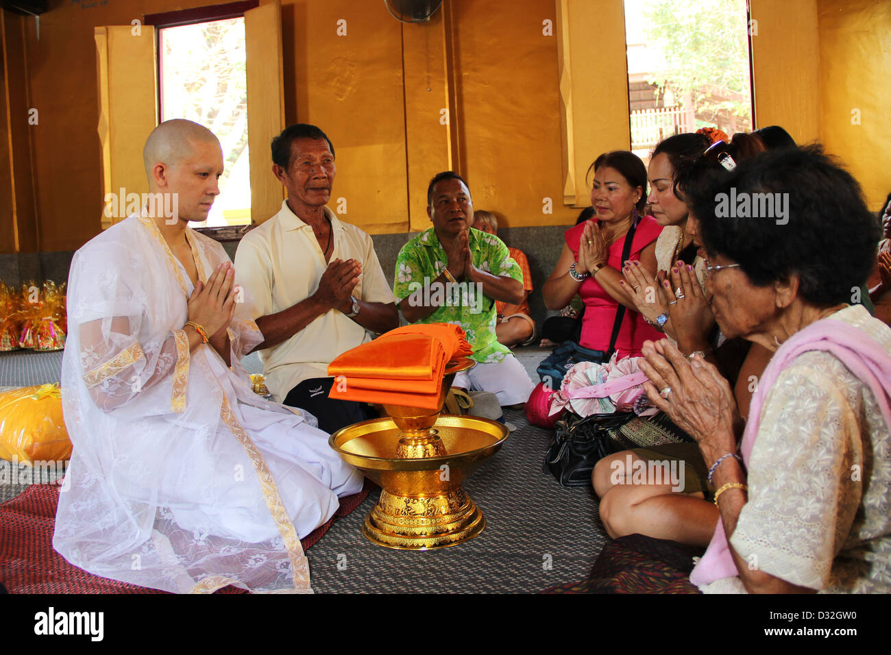 A young novice monk at his initiation ceremony receiving blessing and ...