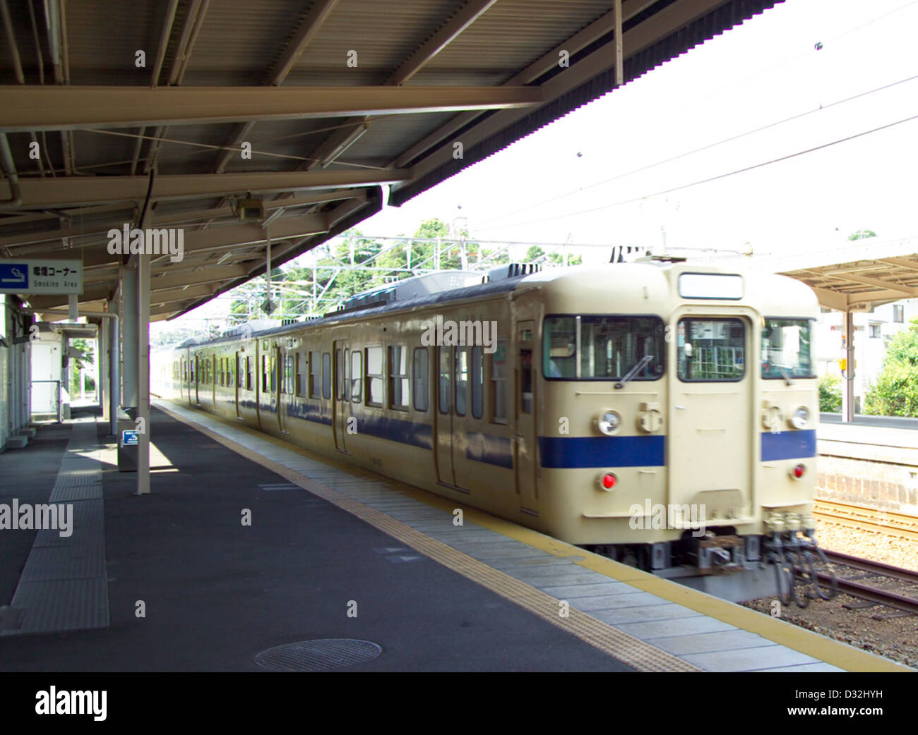 A JR West train departs from Miyajimaguchi Station on the Sanyo Main ...