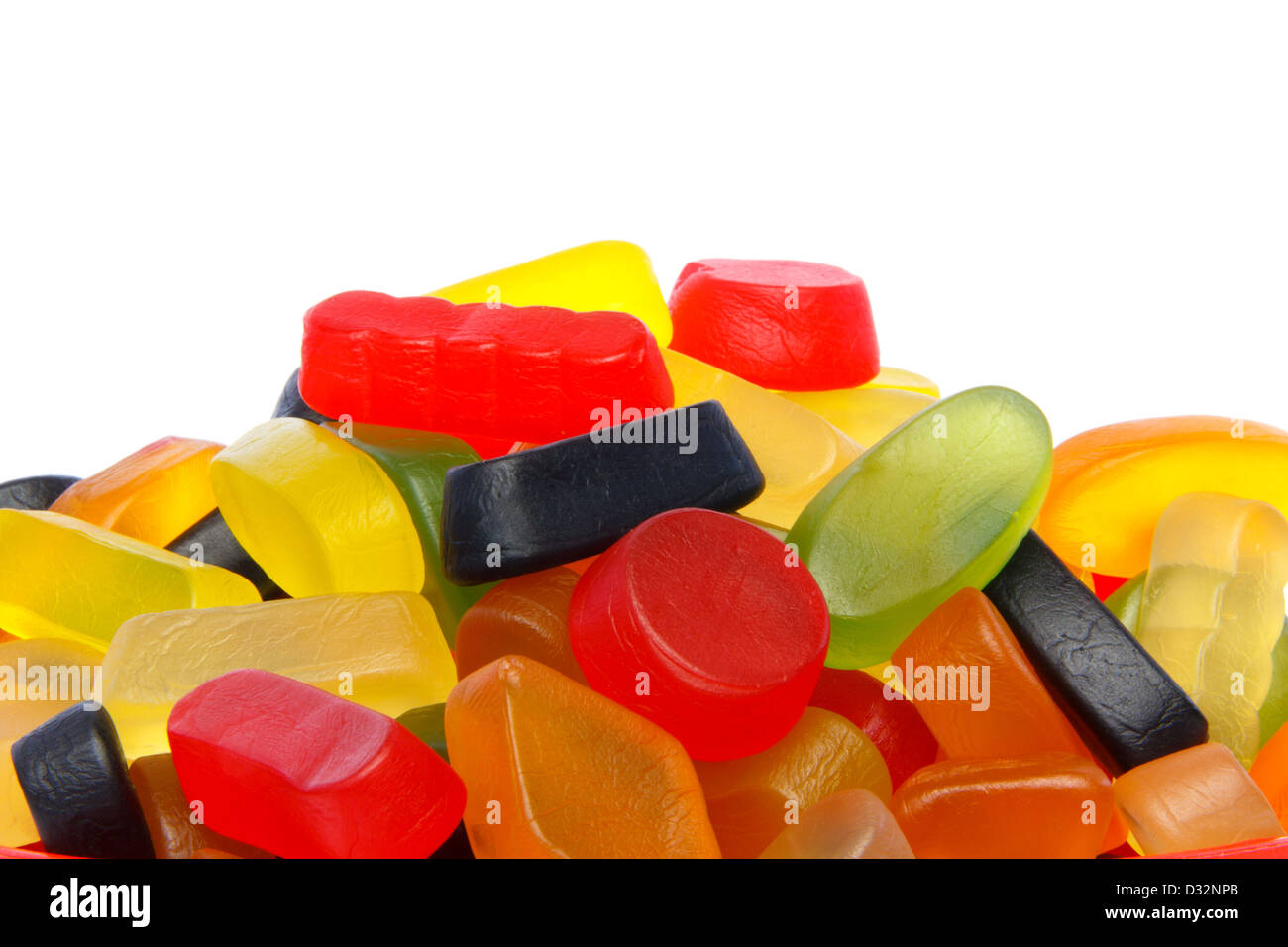 Pile of colorful candy against white background Stock Photo - Alamy