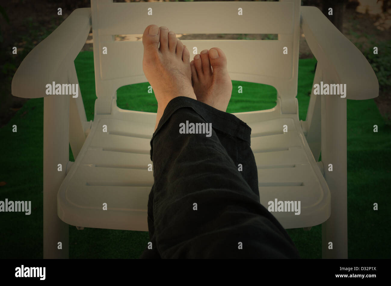 Man laying on chair Stock Photo - Alamy