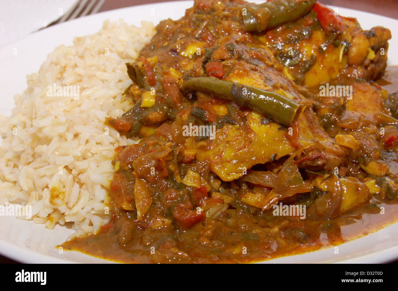 Plate of chicken curry with brown rice Stock Photo - Alamy