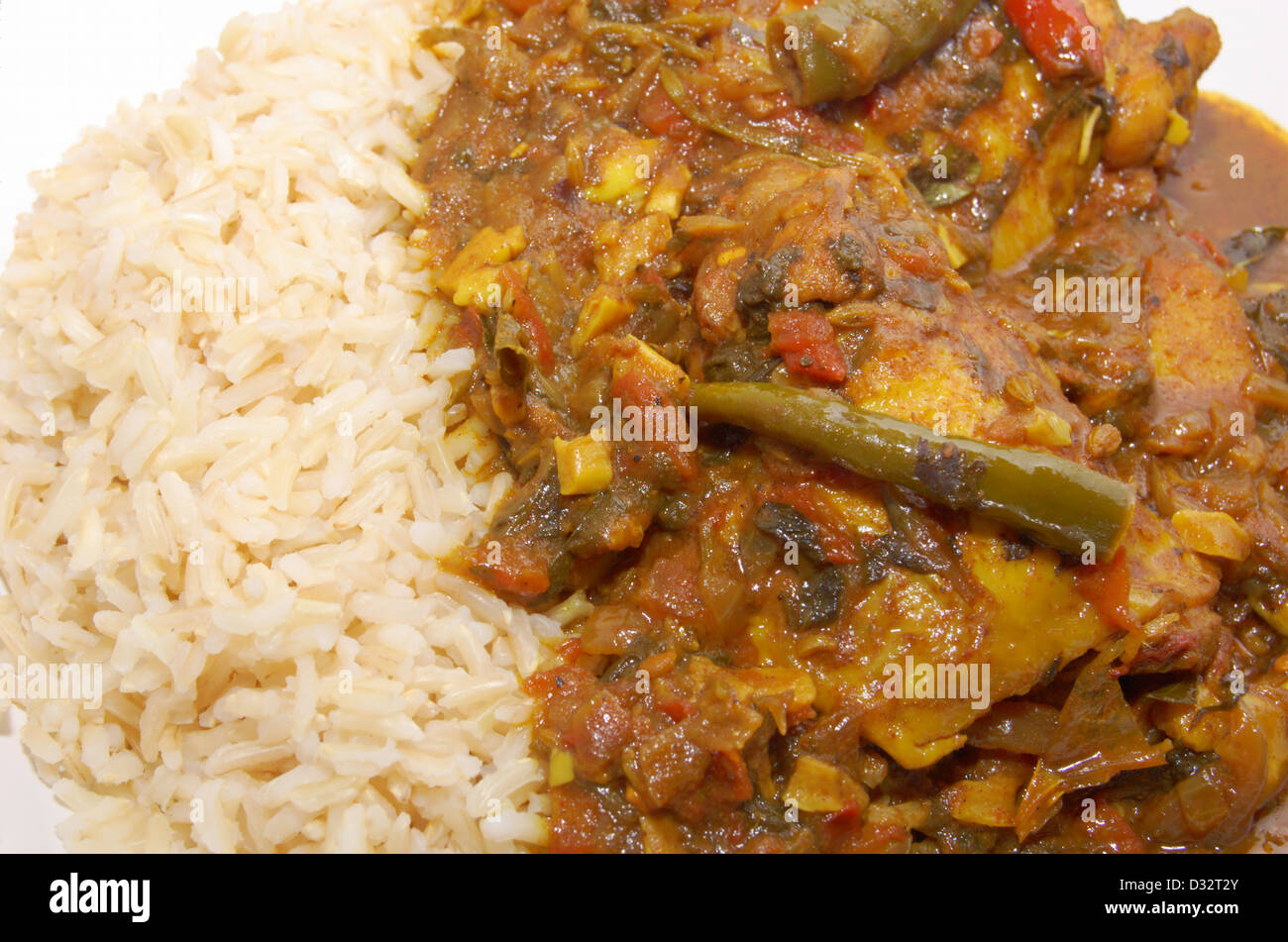 Plate of chicken curry with brown rice Stock Photo - Alamy