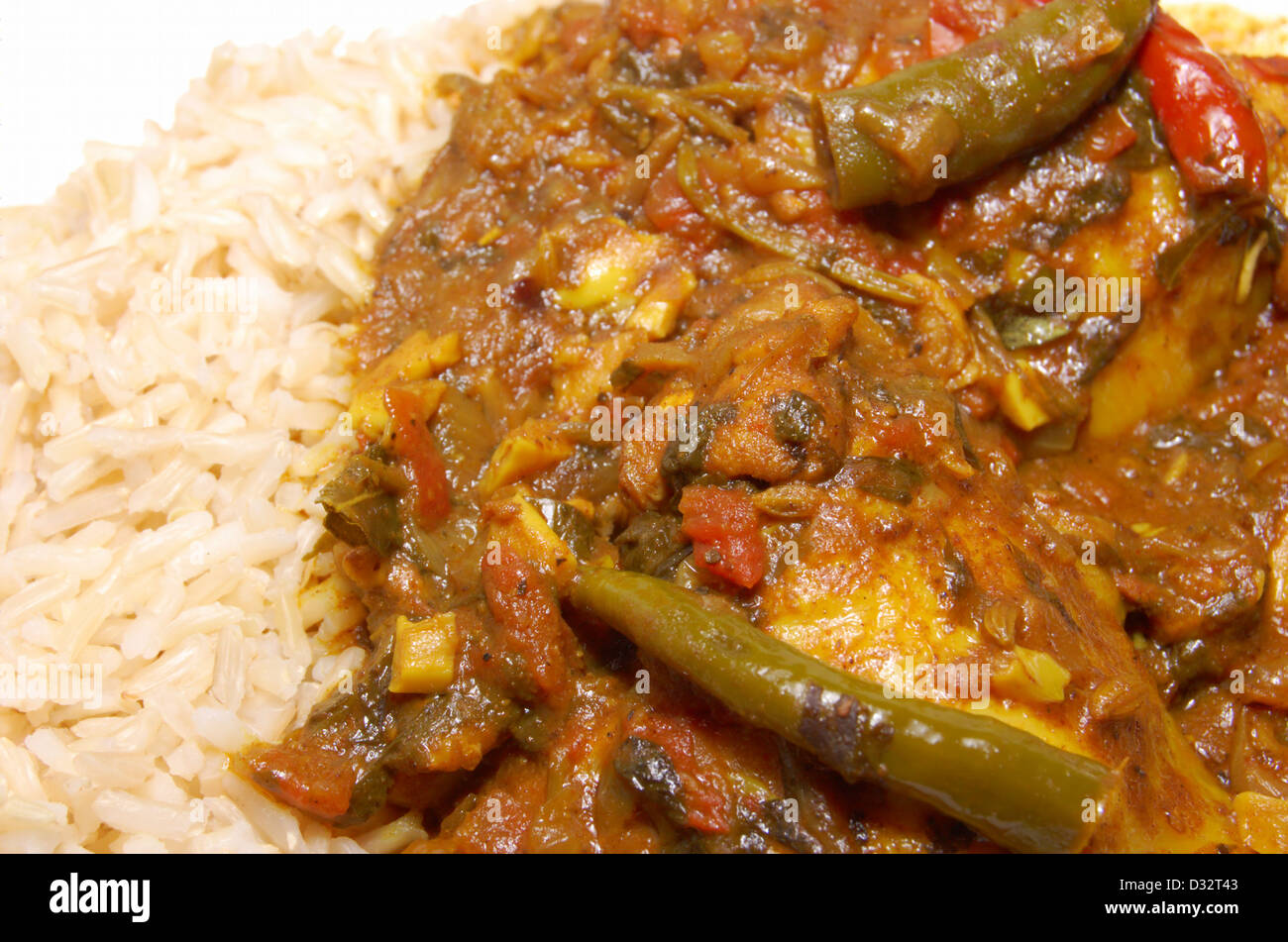 Plate of chicken curry with brown rice Stock Photo - Alamy