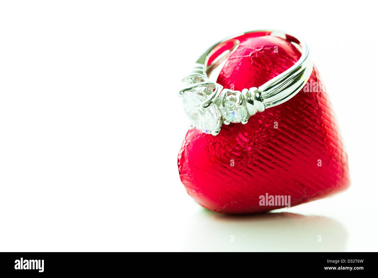 Heart shape chocolate candies wrapped in red foil for Valentine's Day ...