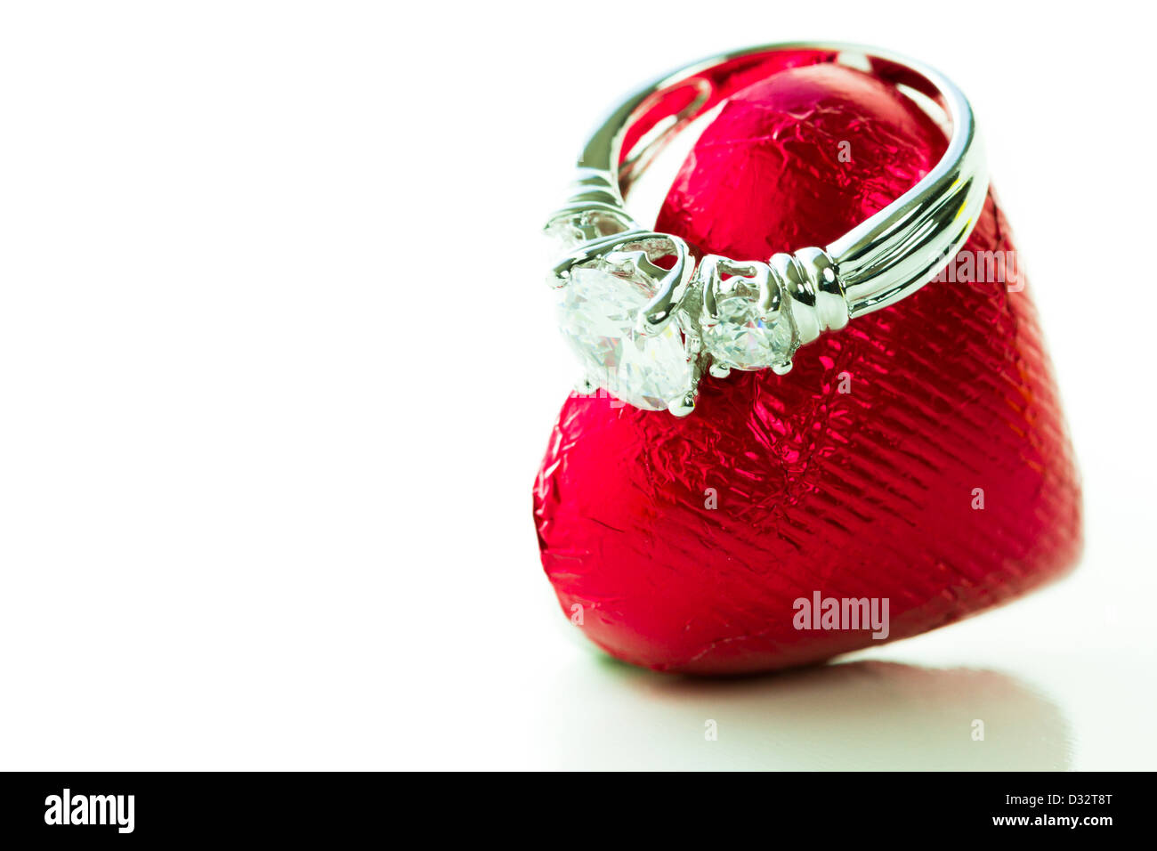 Heart shape chocolate candies wrapped in red foil for Valentine's Day ...