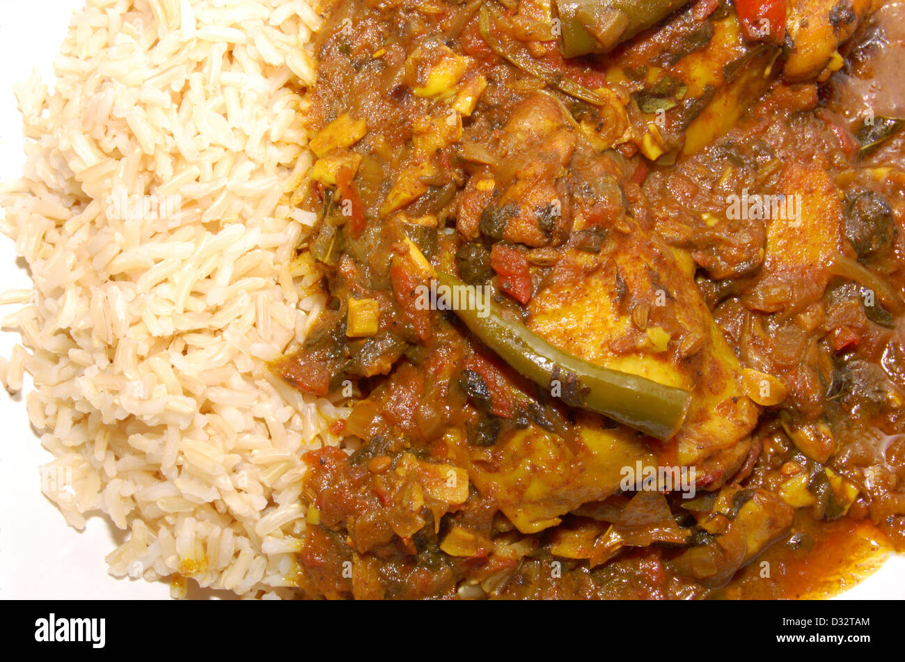 Plate of chicken curry with brown rice Stock Photo - Alamy