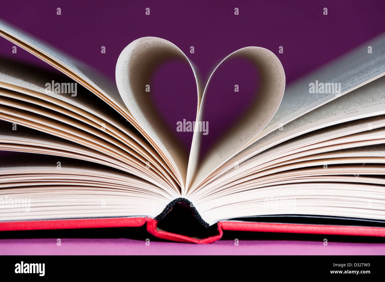 Book pages folded together into a heart shape Stock Photo - Alamy