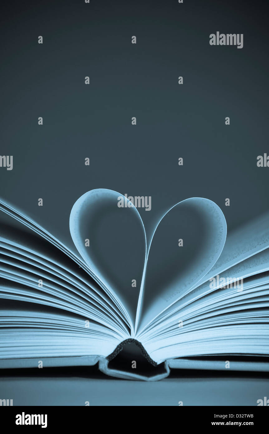 Book pages folded together into a heart shape Stock Photo - Alamy