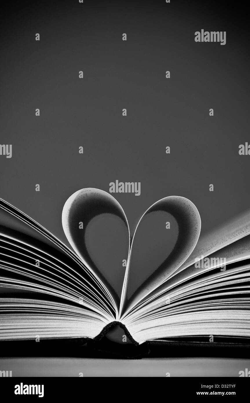Book pages folded together into a heart shape Stock Photo - Alamy