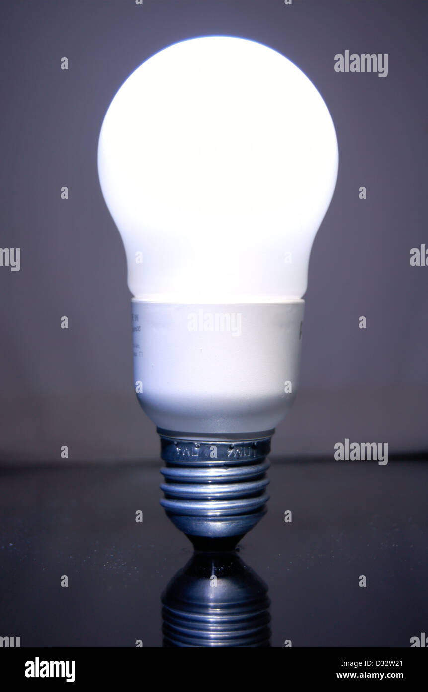 Lit light bulb on a reflective surface Stock Photo - Alamy