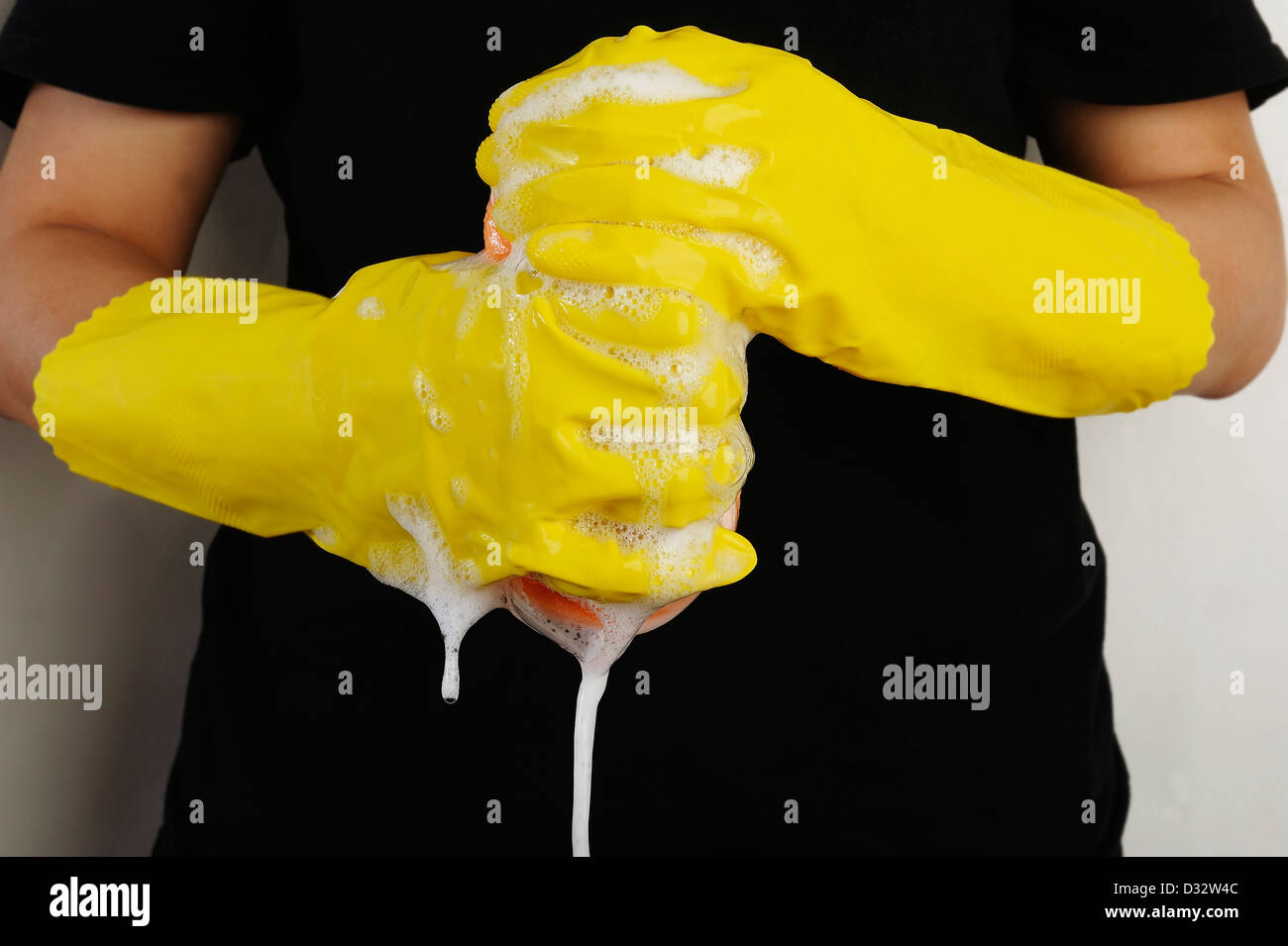 gloved hand squeezes a sponge for cleaning Stock Photo - Alamy