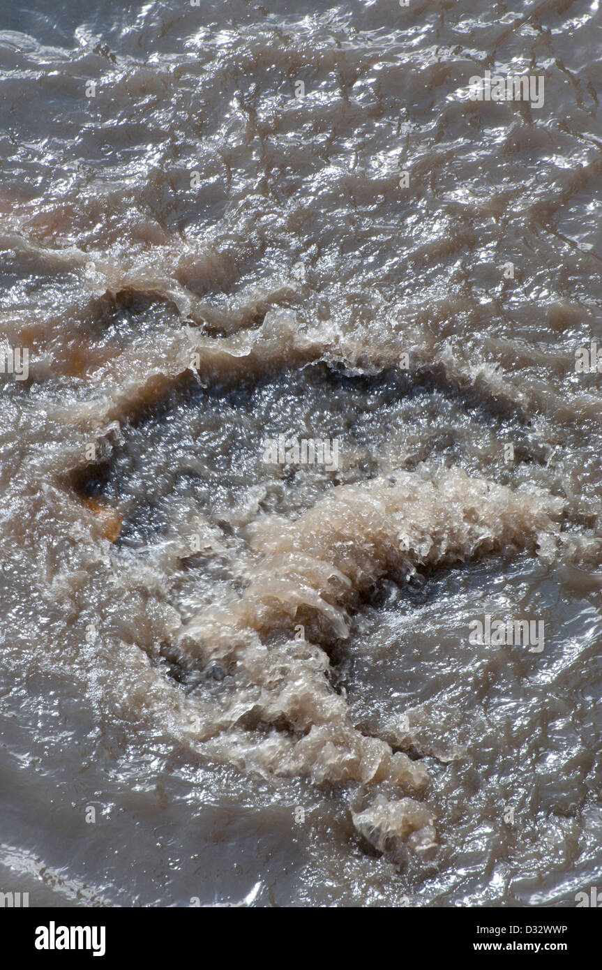 road gully, overflowing. flash flood, heavy rainfall, swirling ...