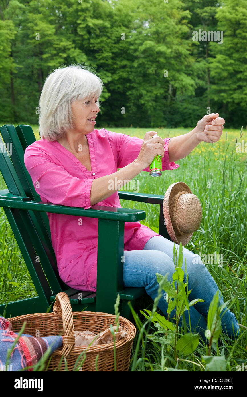 Woman spraying insect repellant hi-res stock photography and images - Alamy