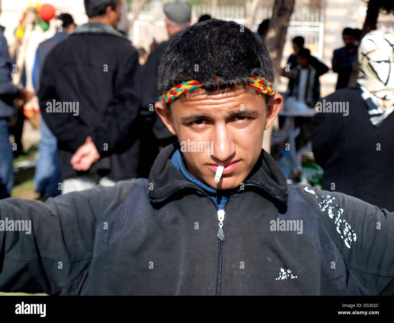 Kurdish boy in headband smoking cigarette in Diyarbakir, Turkey Stock ...