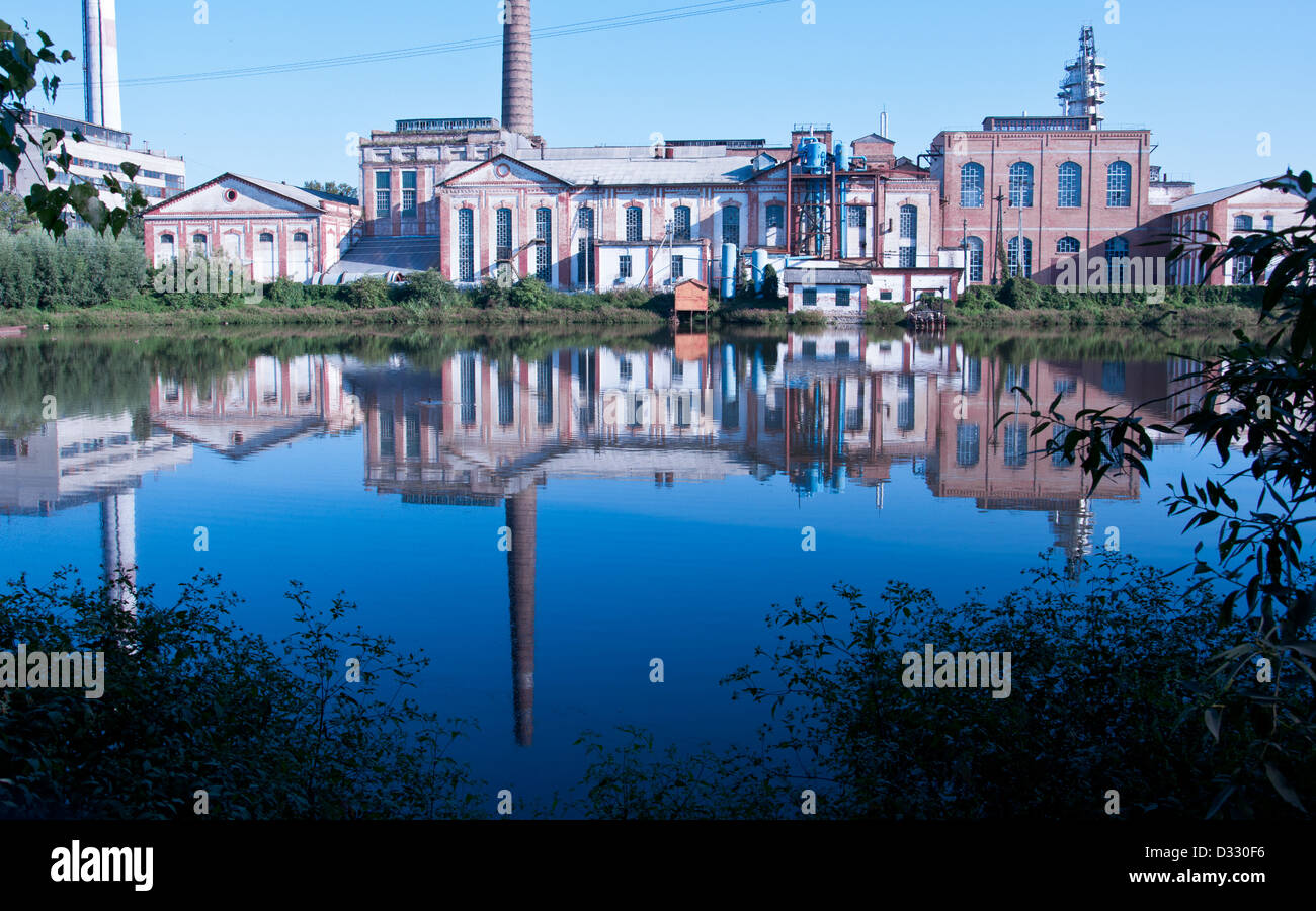 Old factory reflected in the lake Stock Photo - Alamy