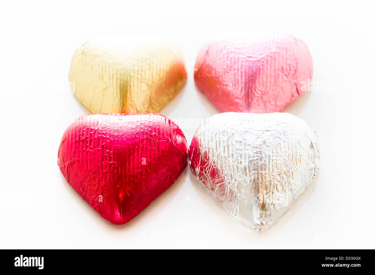 Heart shape chocolate candies wrapped in colorful foil for Valentine's ...
