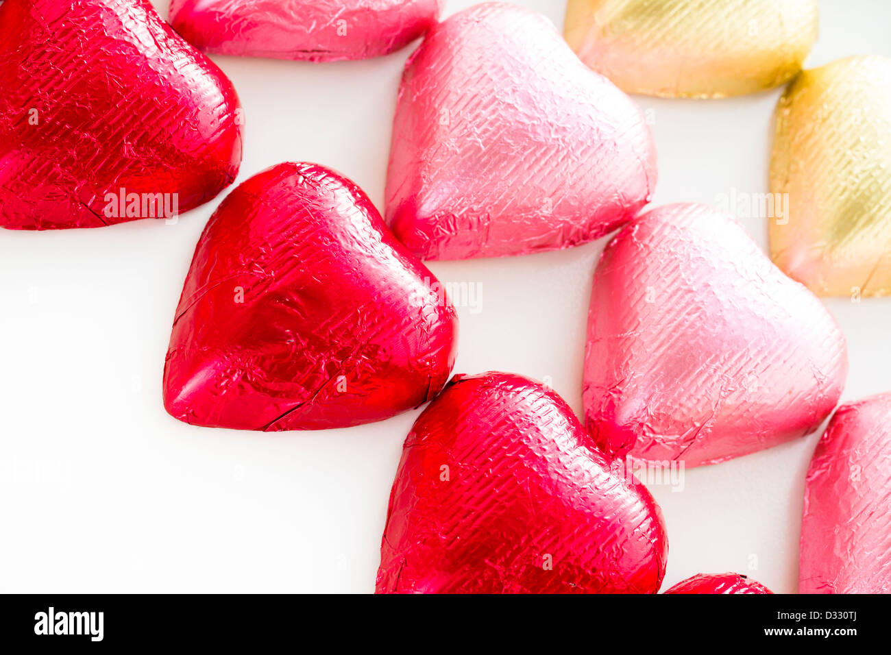 Heart shape chocolate candies wrapped in colorful foil for Valentine's ...