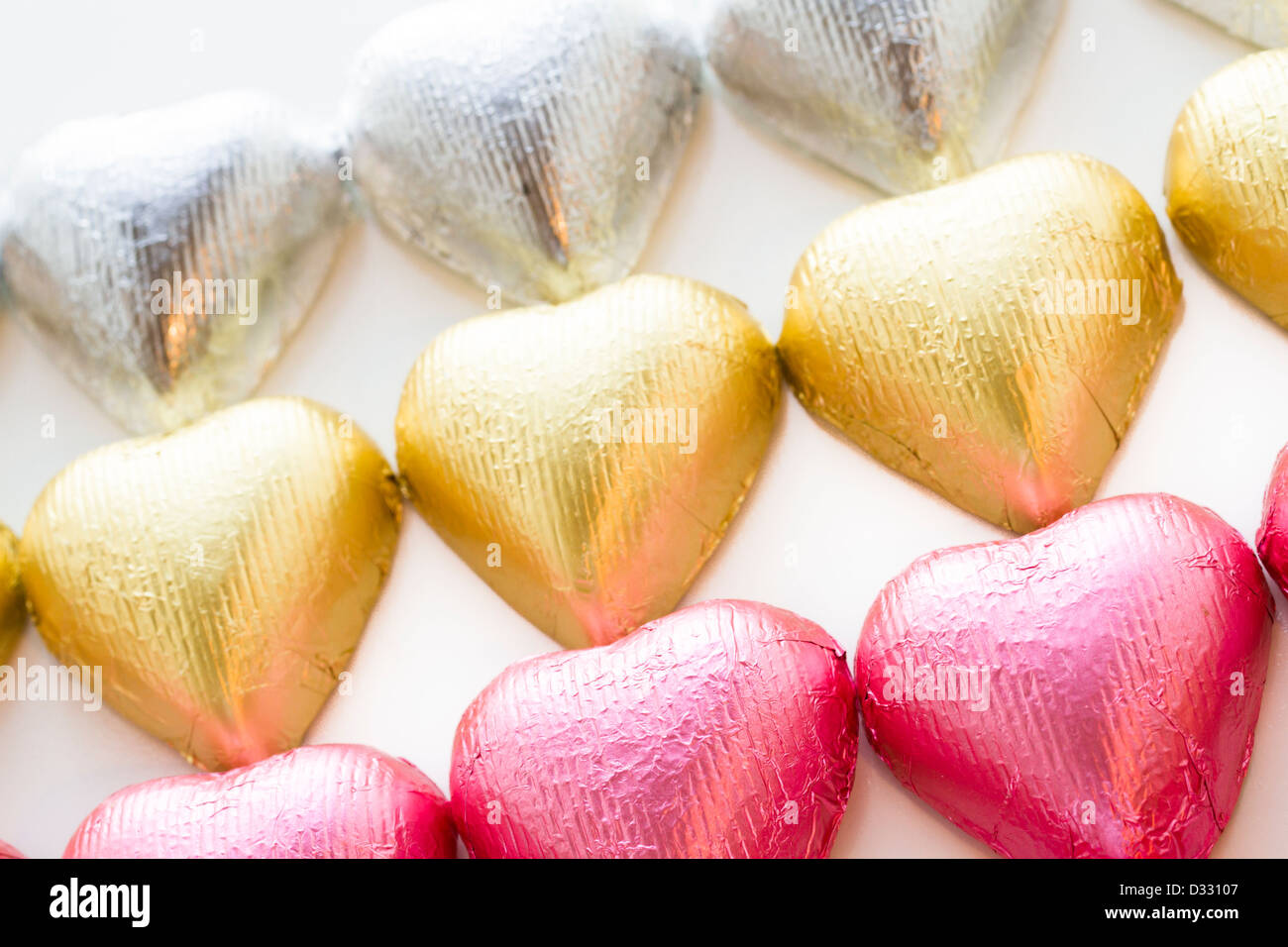 Heart shape chocolate candies wrapped in colorful foil for Valentine's ...