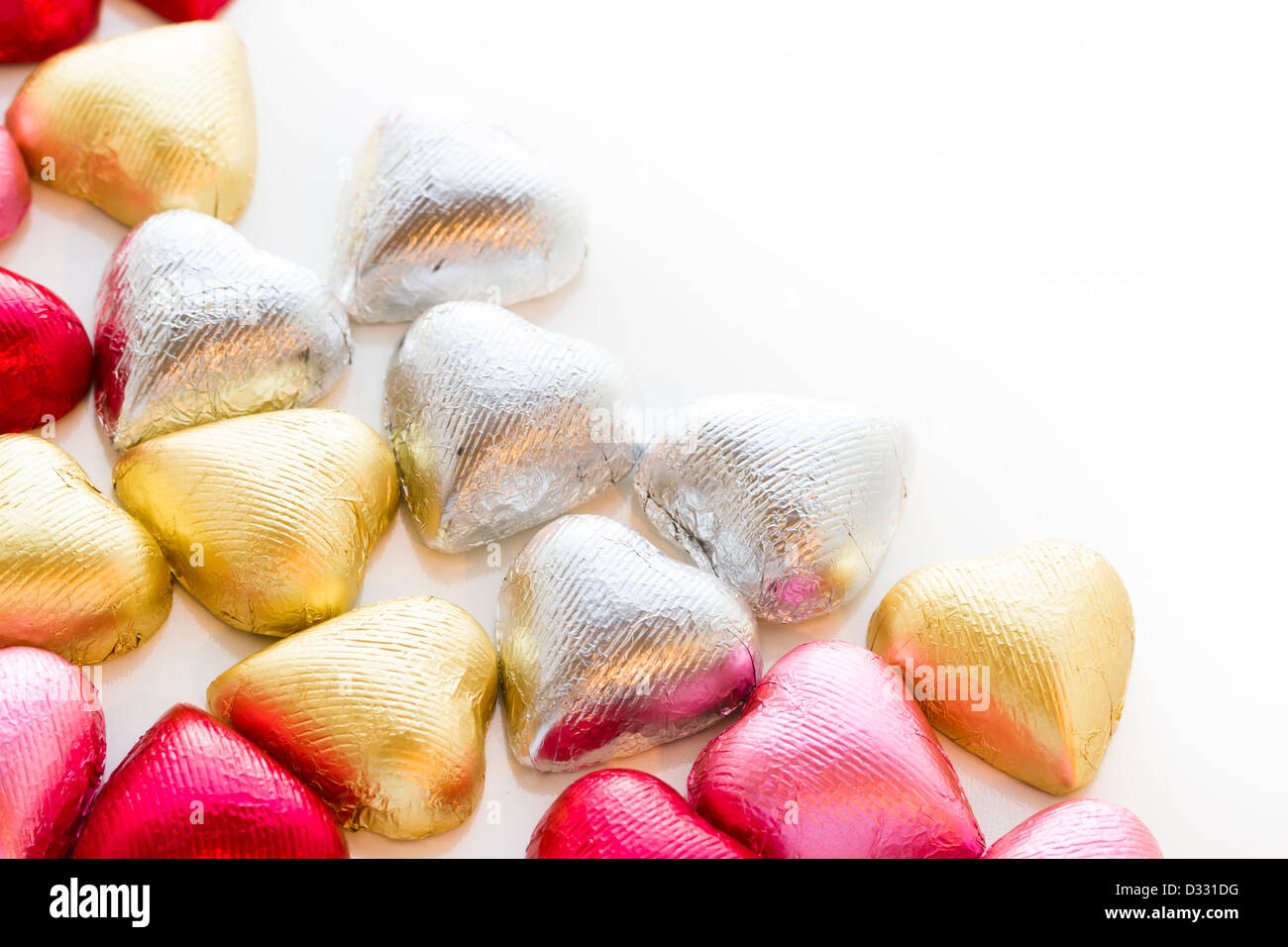 Heart shape chocolate candies wrapped in colorful foil for Valentine's ...