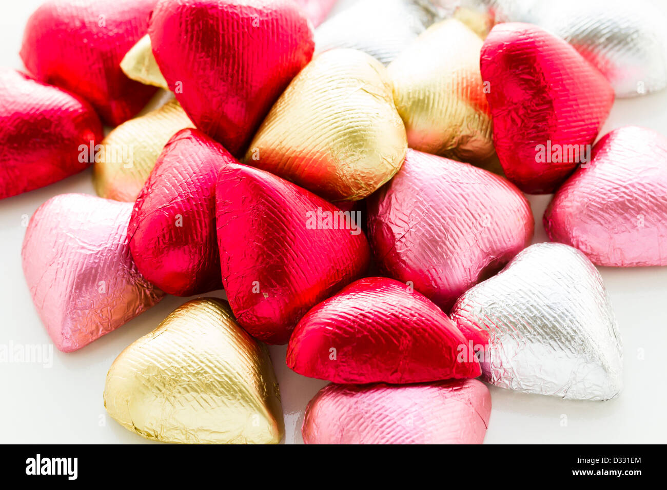 Heart shape chocolate candies wrapped in colorful foil for Valentine's ...