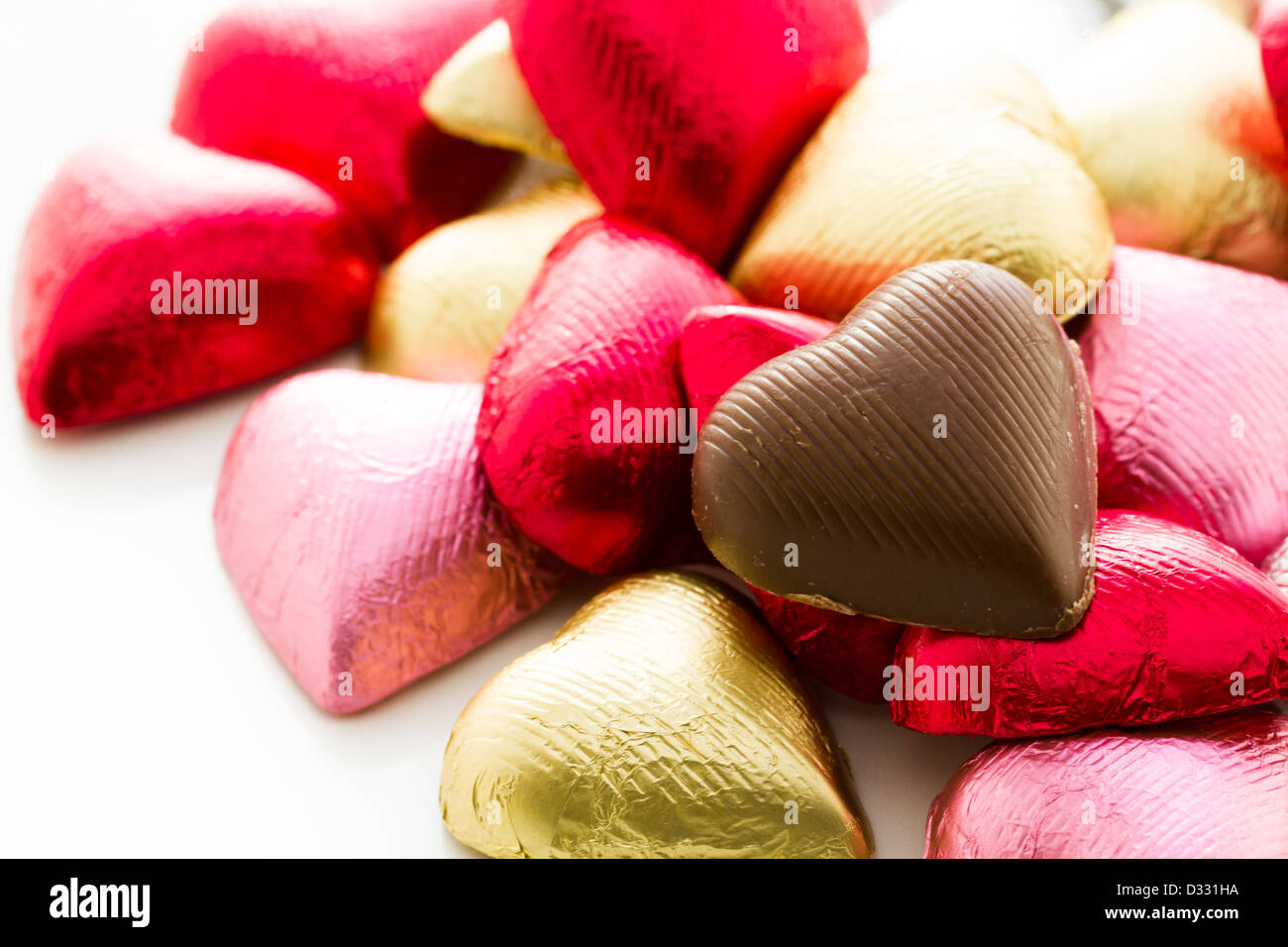 Heart shape chocolate candies wrapped in colorful foil for Valentine's ...