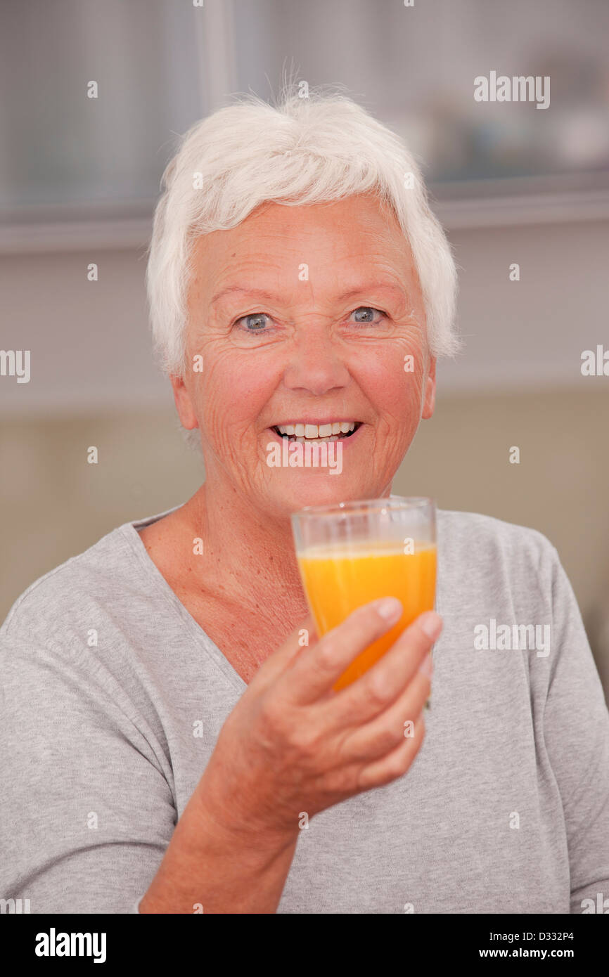 Elderly woman drinking fruit juice hi-res stock photography and images ...