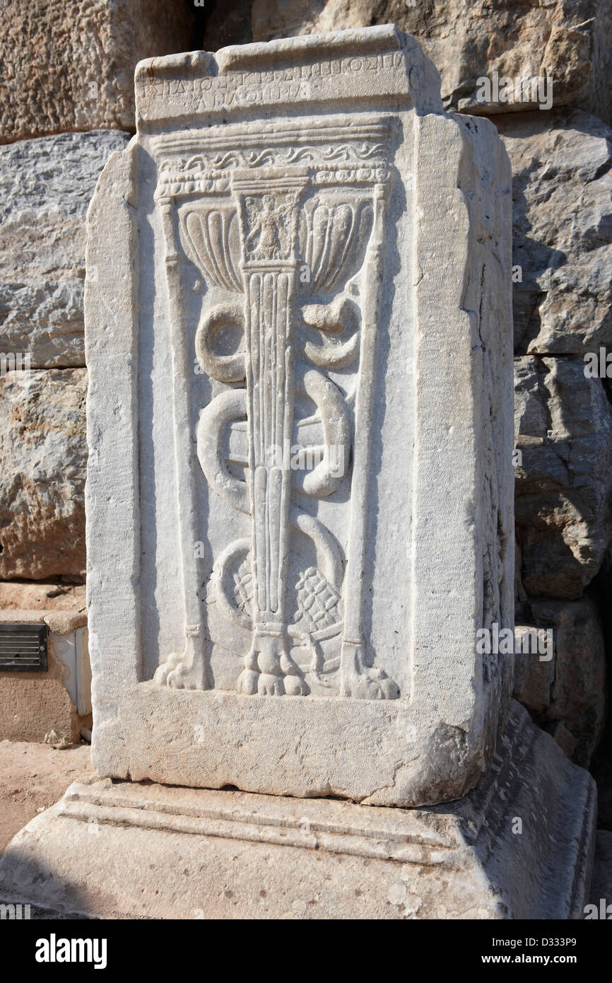 Ancient stone with carved snake on a staff - symbol of Asclepius, the ...
