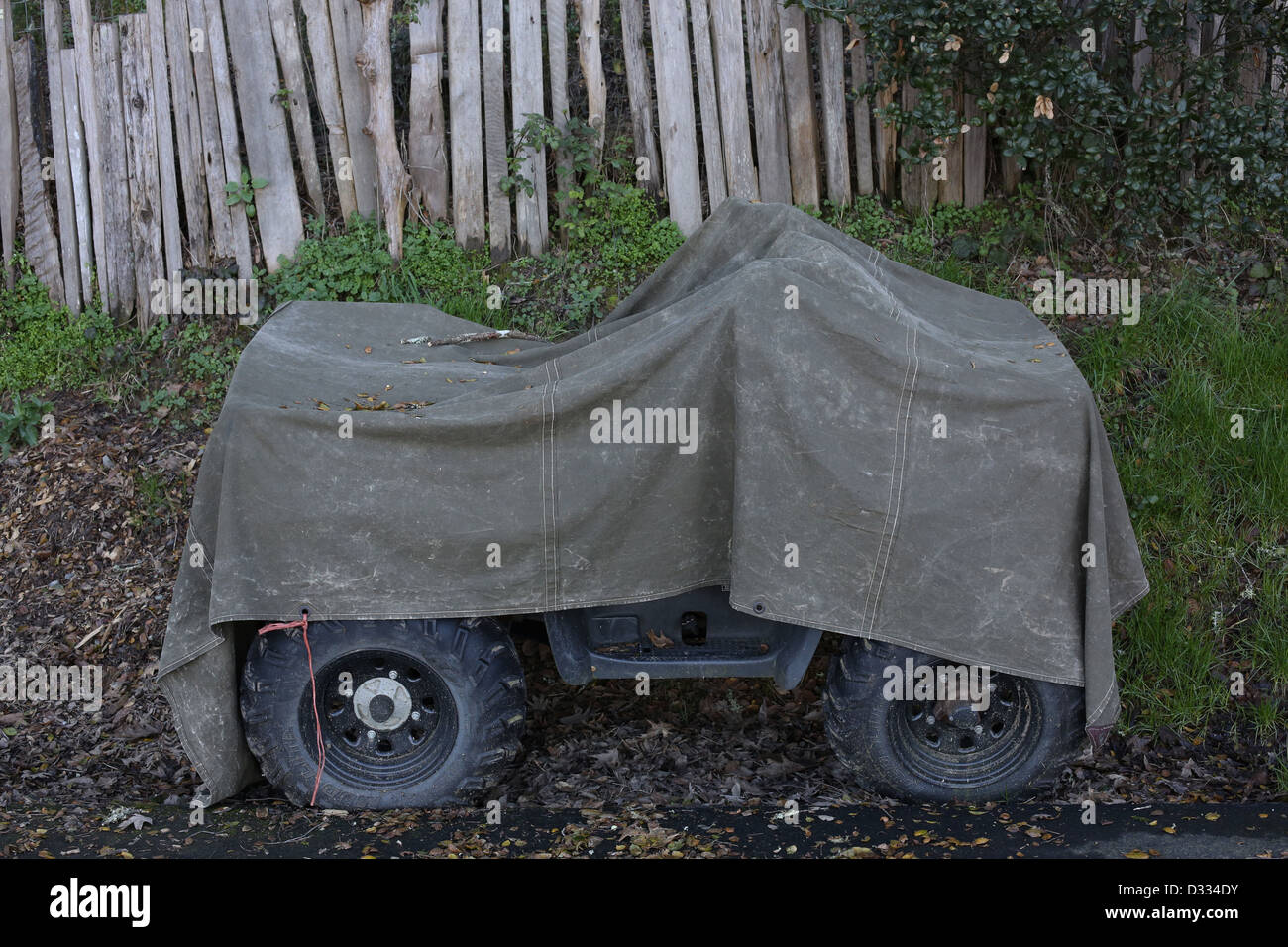 An all terrain vehicle covered with a tarp Stock Photo - Alamy