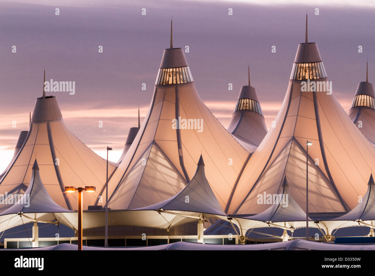Glowing tents of DIA at sunrise. Denver International Airport well ...