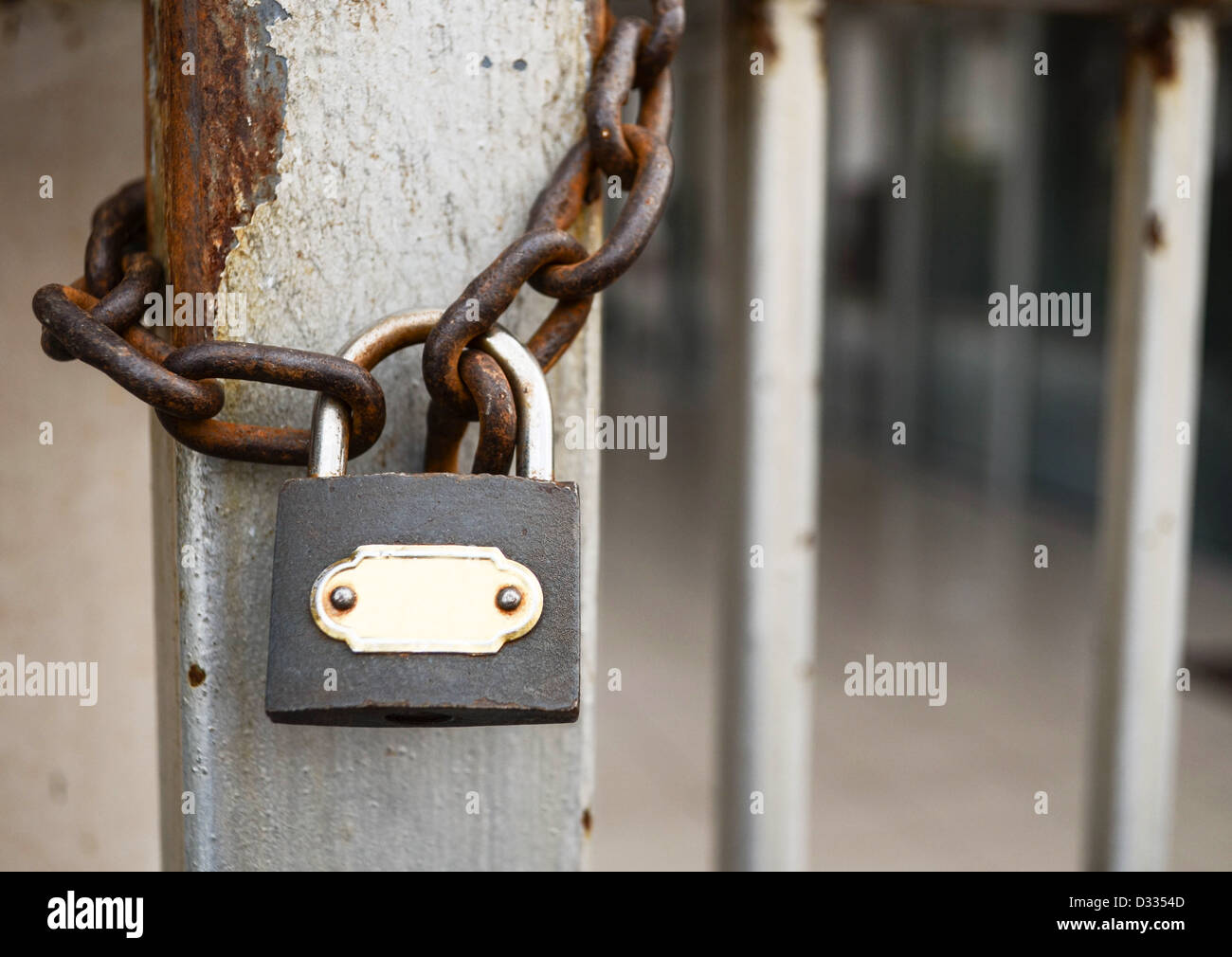 Rusted padlock on closed iron door Stock Photo - Alamy
