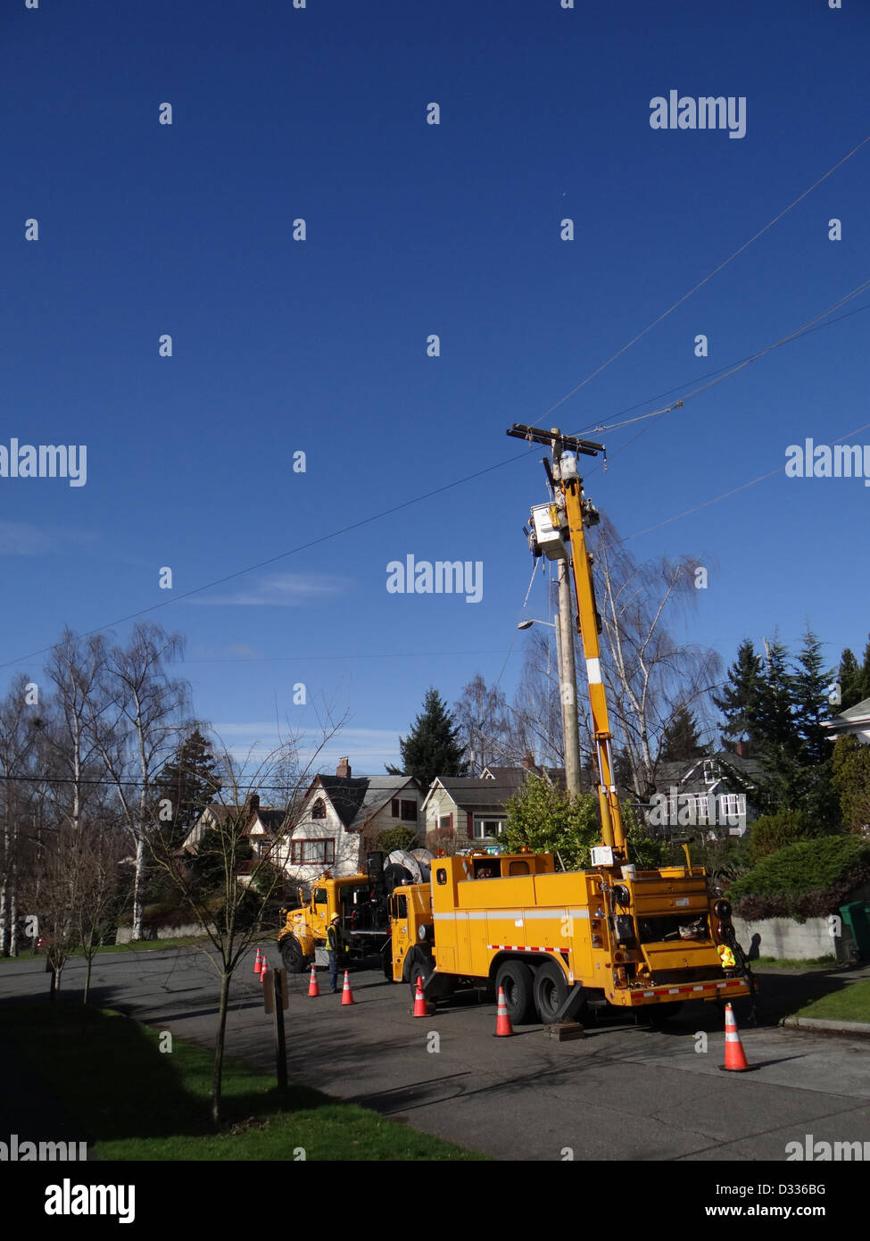 Seattle City Light workmen replace an aging utility pole as part of a ...