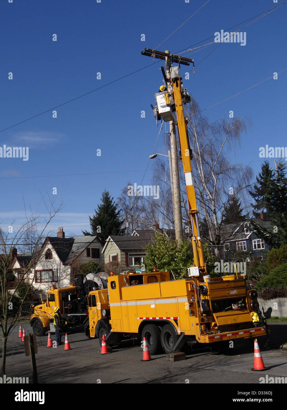 Seattle City Light workmen replace an aging utility pole as part of a ...